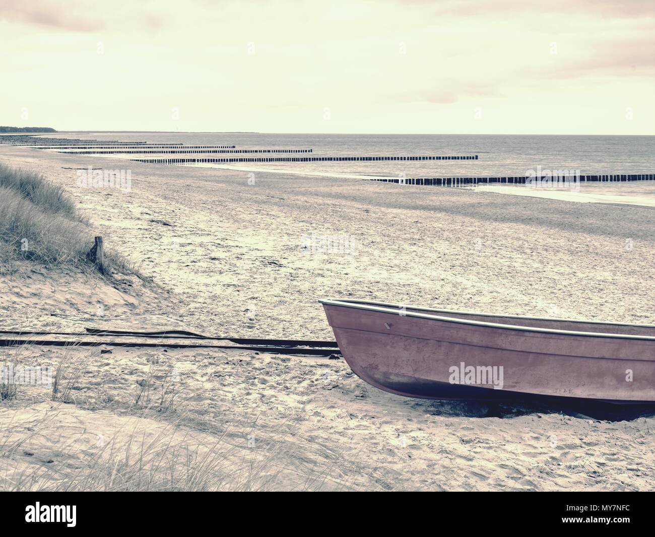 Small wrecked ship, wooden boat anchored at the sea, moody morning ...
