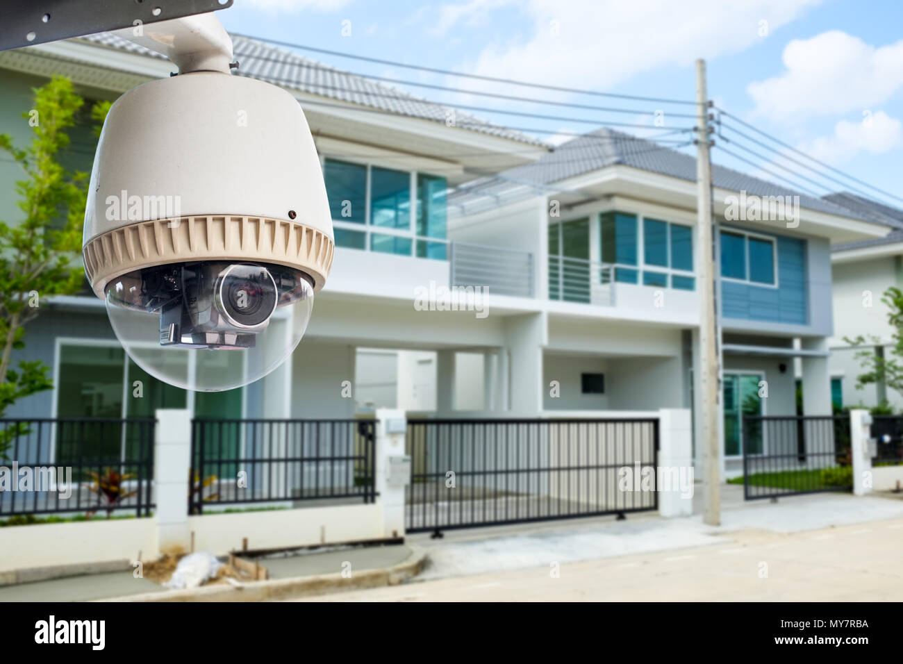 CCTV Camera or surveillance operating with house village in background ...