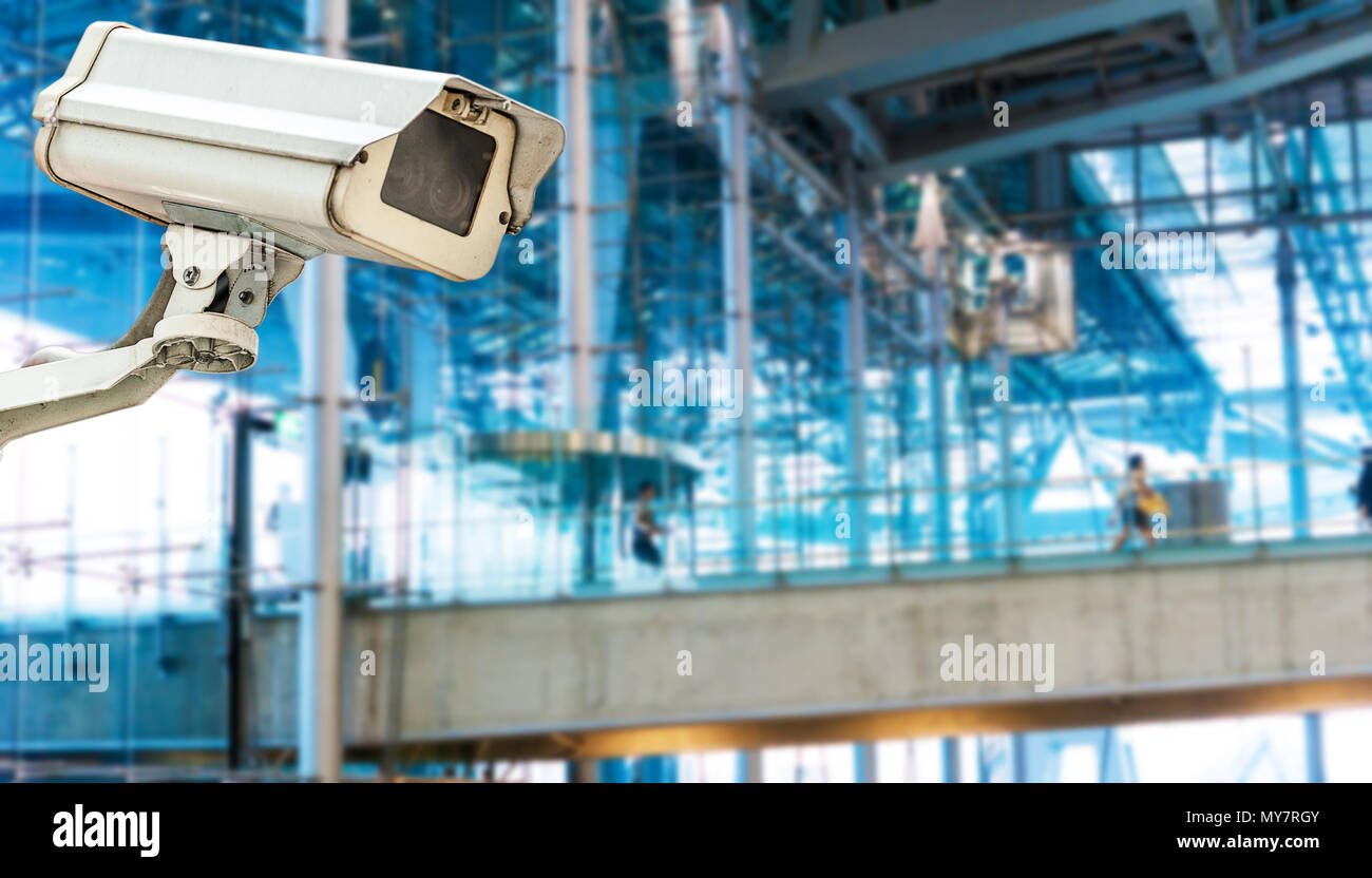 CCTV camera or surveillance operating with electric door in background ...