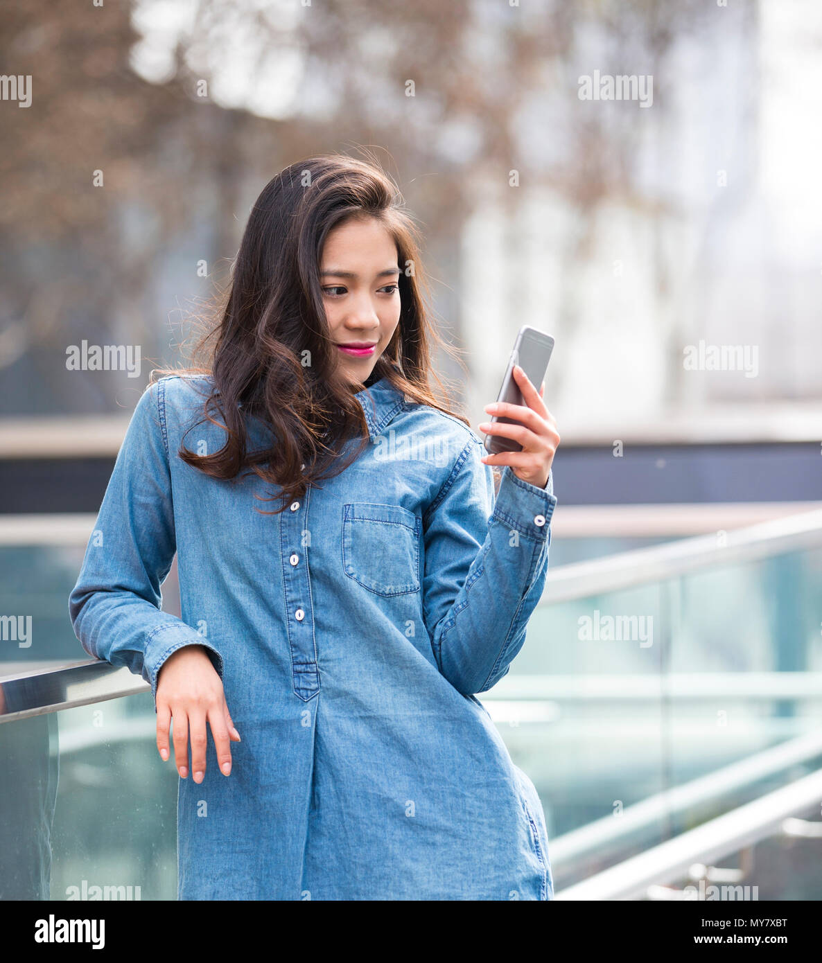 Picture of One beautiful young Chinese woman using mobile phone outdoor ...