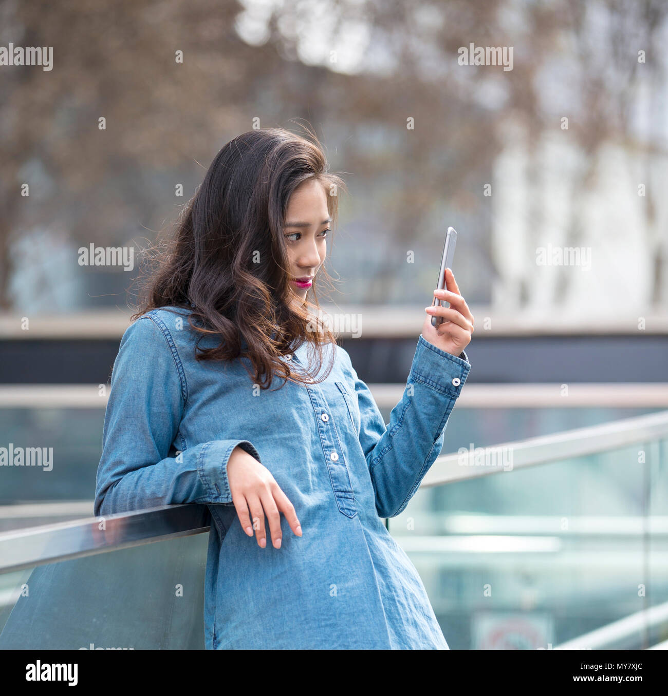Picture of One beautiful young Chinese woman using mobile phone outdoor ...