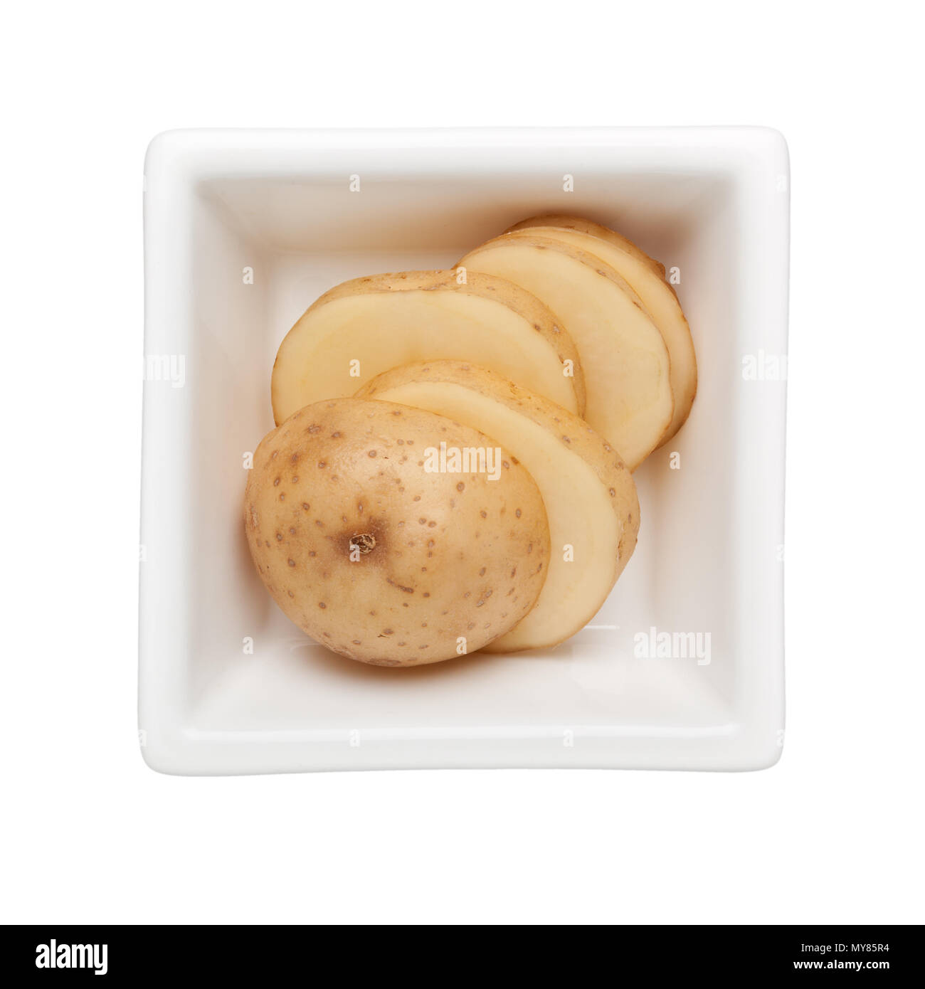 Pieces of sliced potato in a square bowl isolated on white background ...