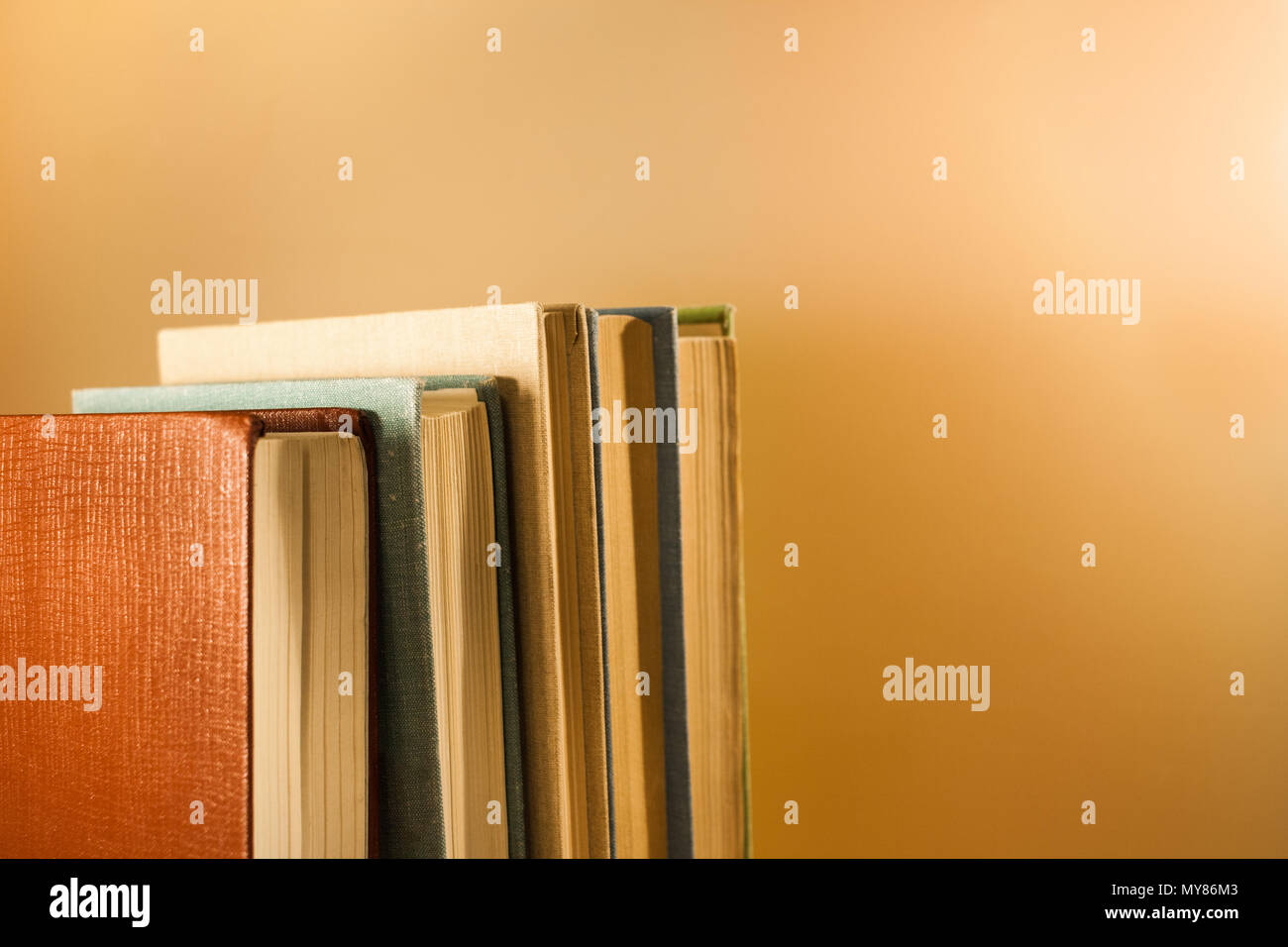 Close-up vertical stack of books on light background with copy space ...