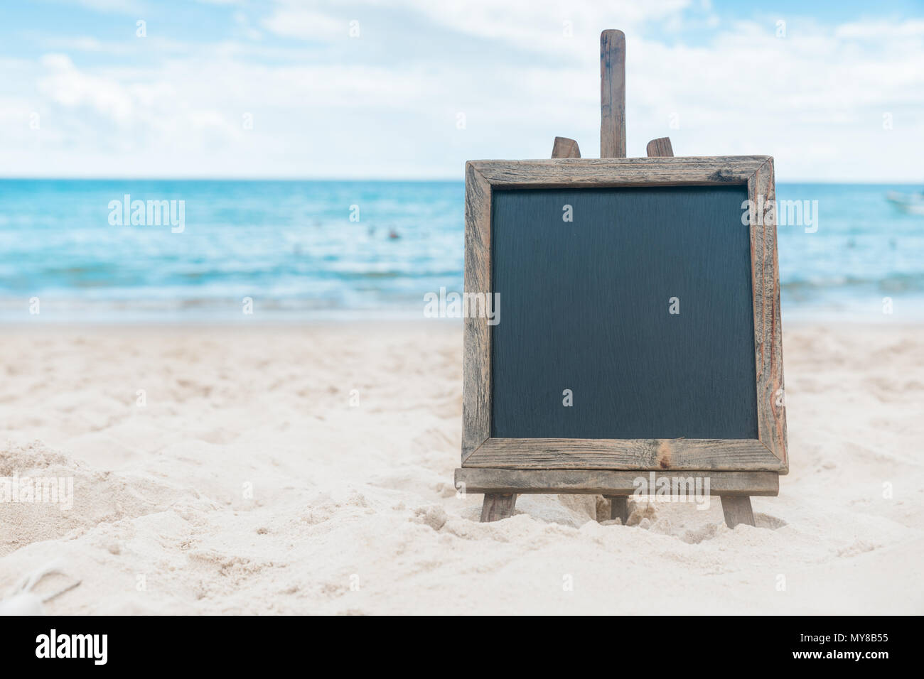 Chalk board with sunscreen cream in the sand on the beach tropic Stock ...