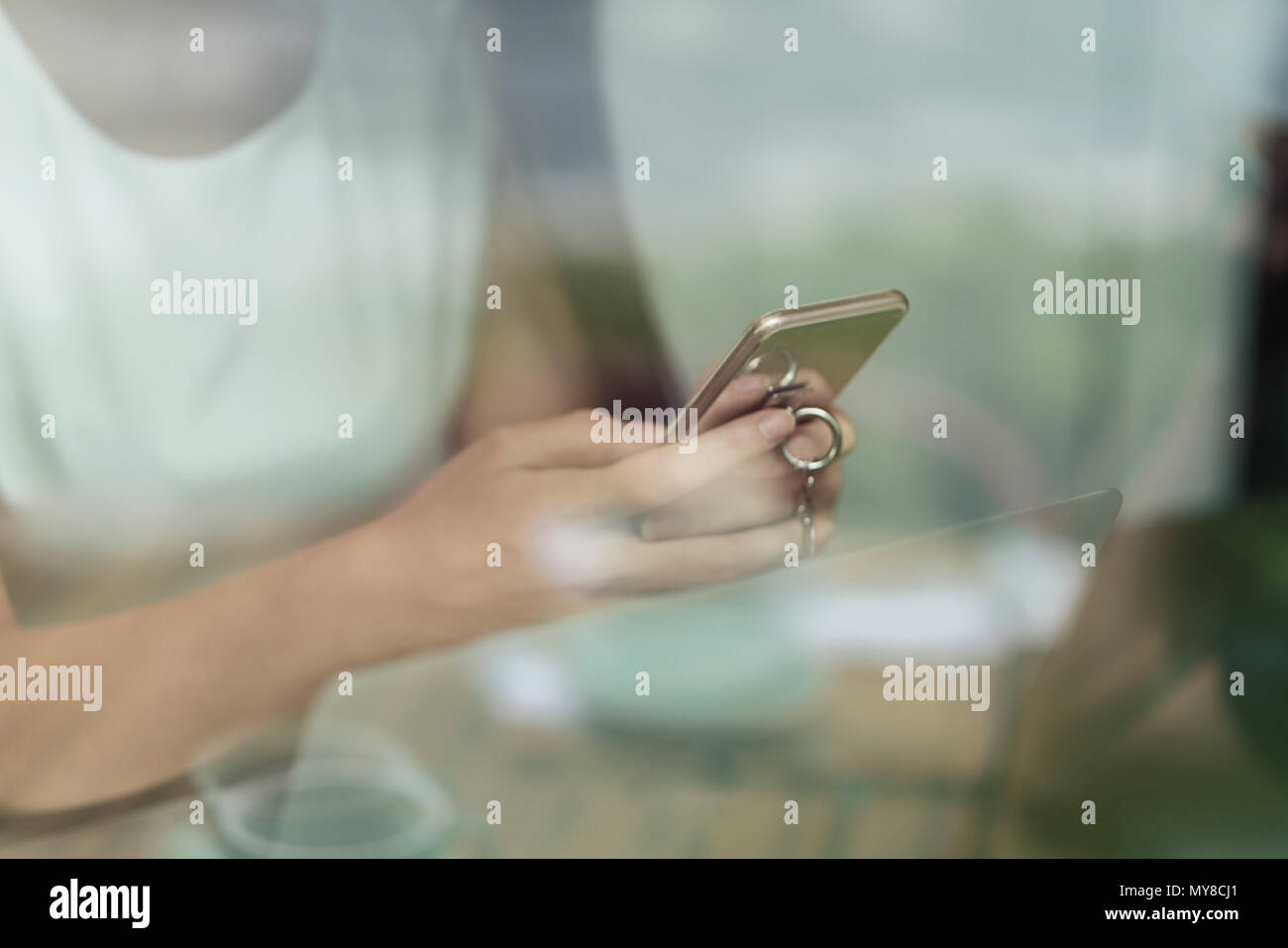 Businesswoman using smartphone and laptop, mid section, close-up Stock ...