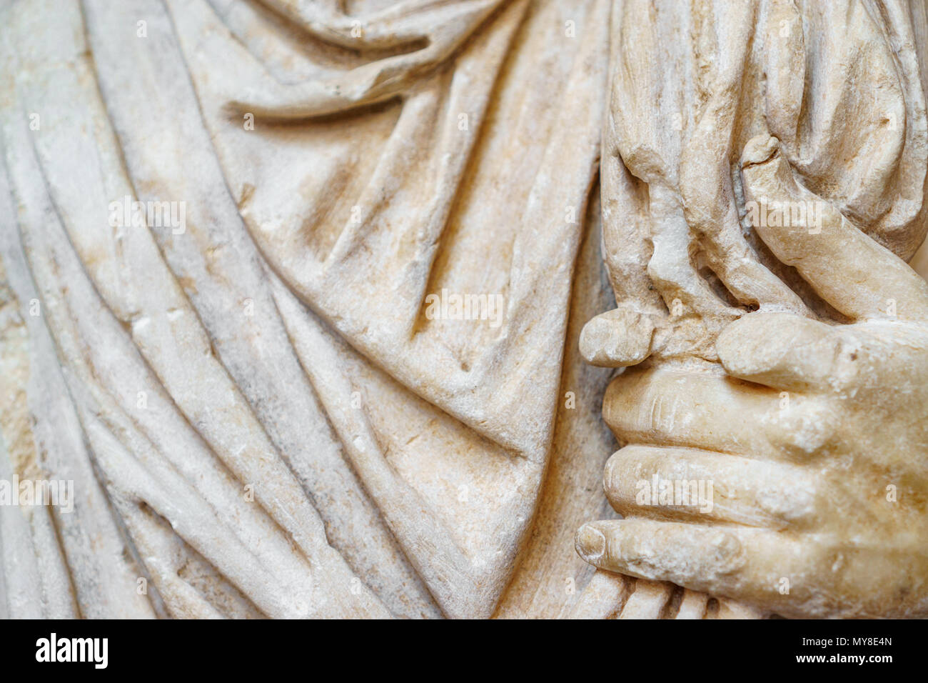 Stone statue with toga and hand Stock Photo - Alamy