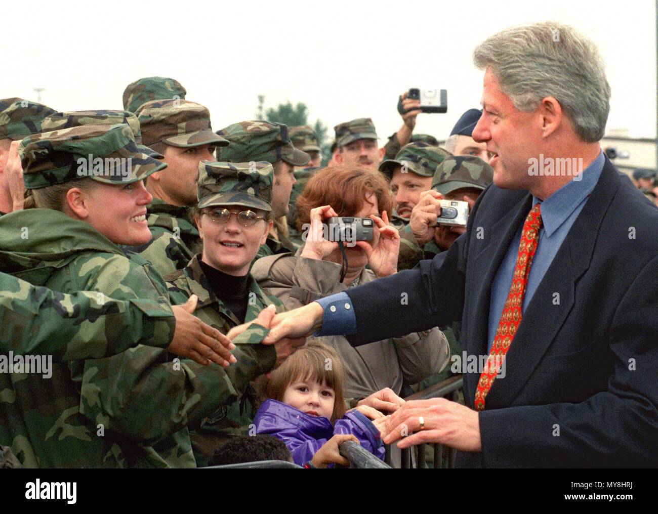 US President Bill Clinton greets a group of female soldiers waiting for ...