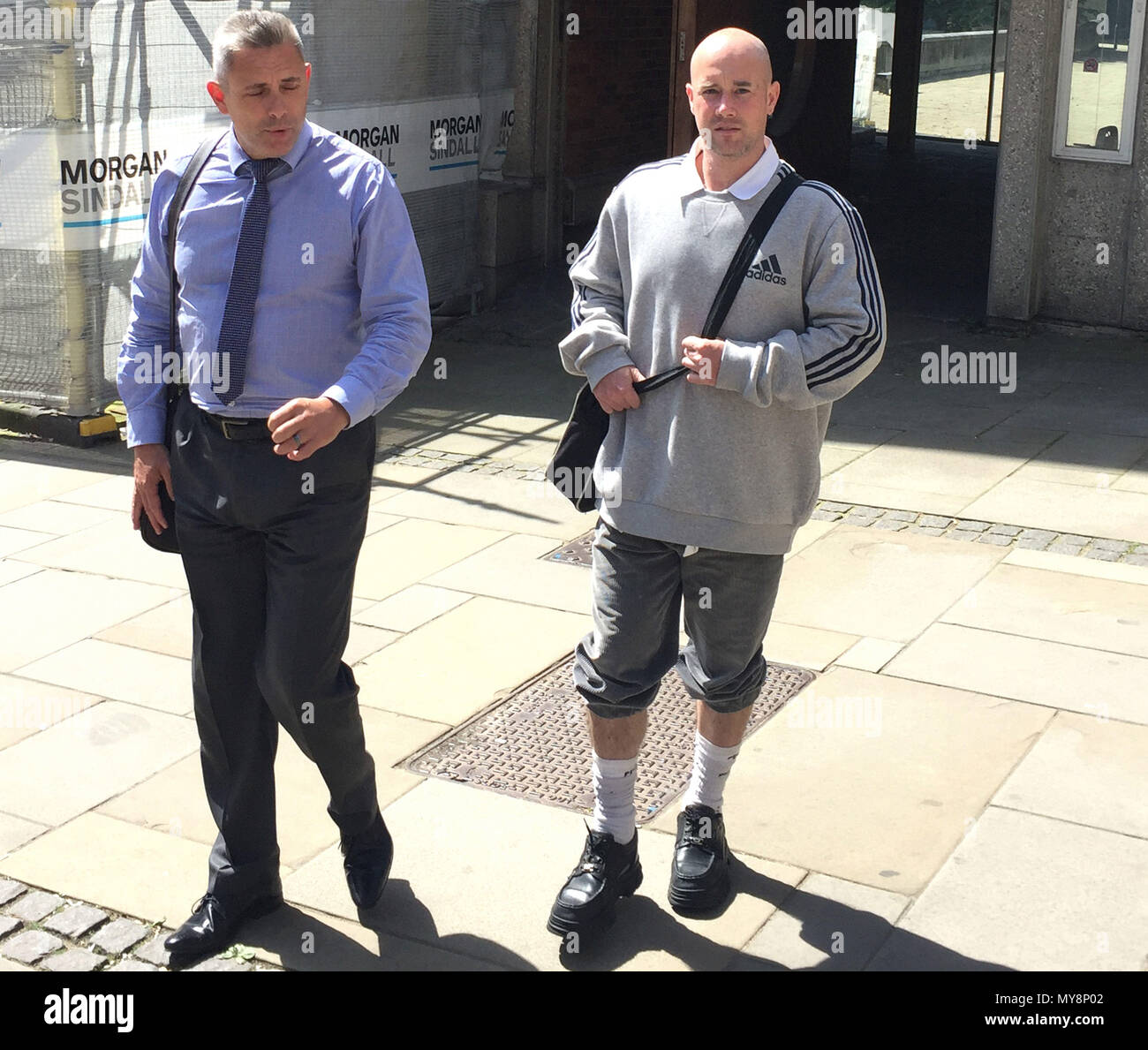 Neil Sutherland (right) leaving Winchester Crown Court after being ...
