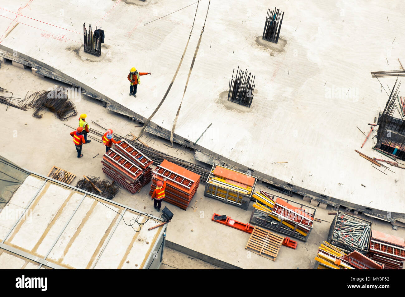 Construction workers working in site lifting tools Stock Photo - Alamy