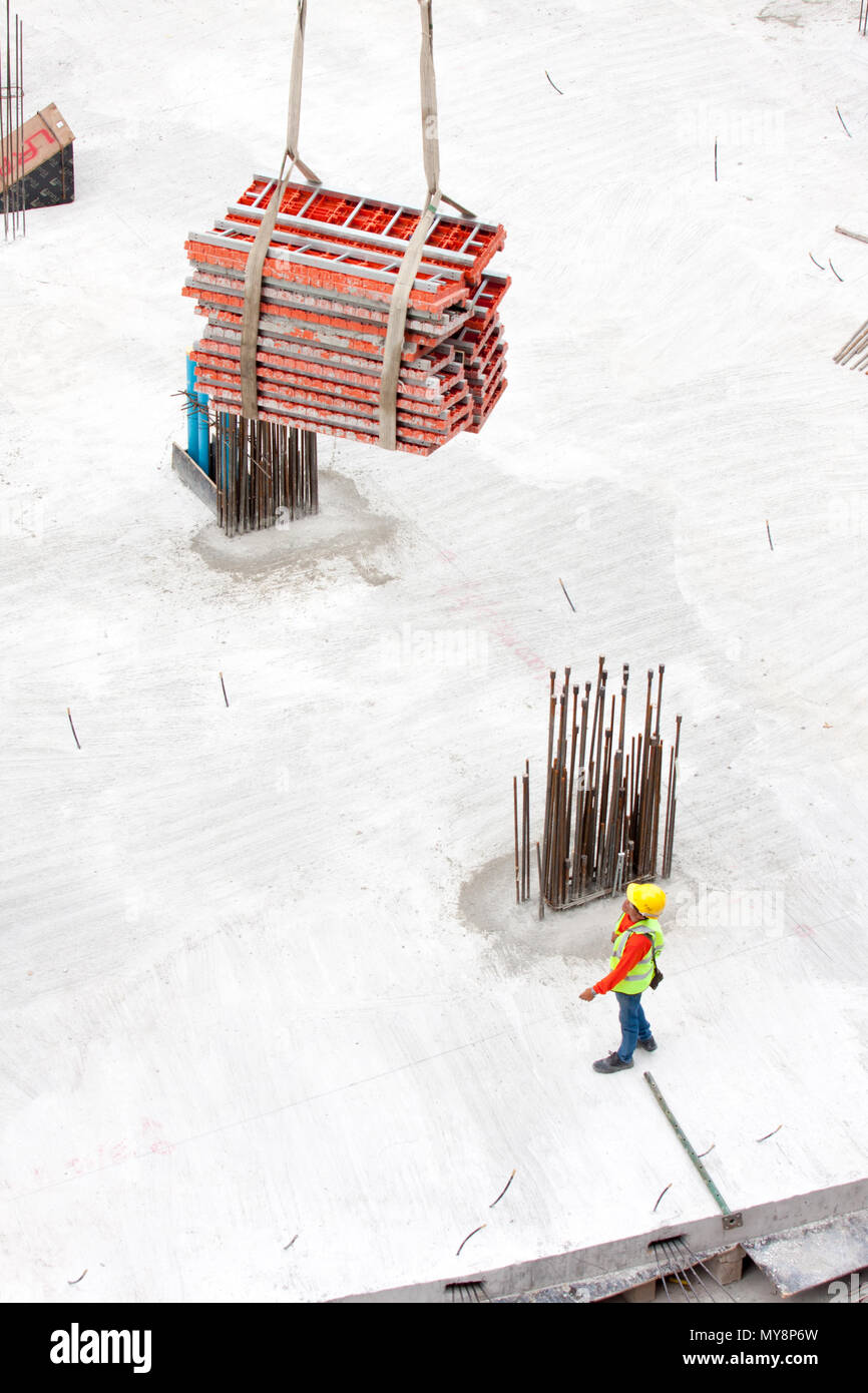 Construction workers working in site lifting tools Stock Photo - Alamy