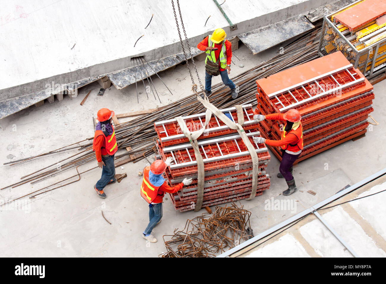 Construction workers working in site lifting tools Stock Photo - Alamy