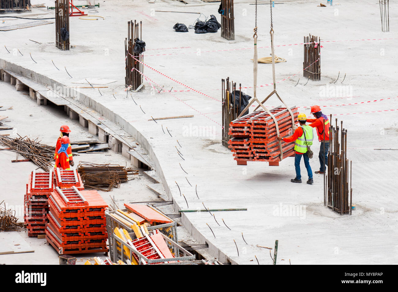 Construction workers working in site lifting tools Stock Photo - Alamy