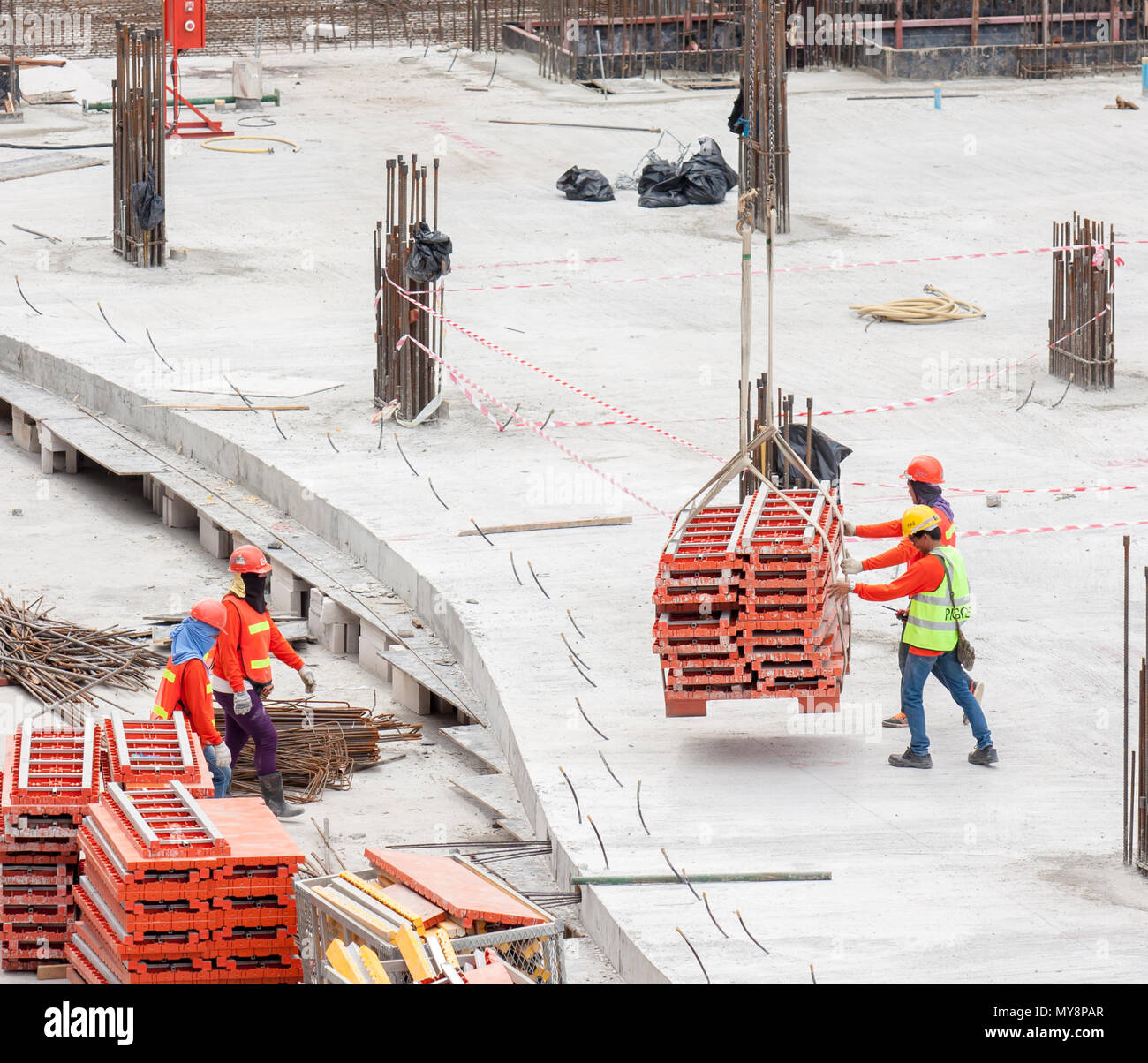 Construction workers working in site lifting tools Stock Photo - Alamy