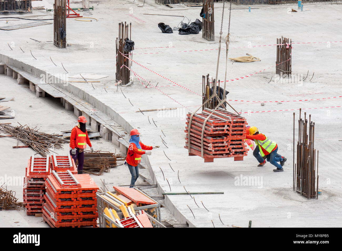 Construction workers working in site lifting tools Stock Photo - Alamy