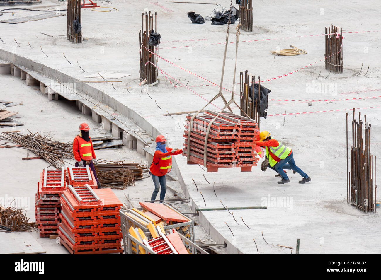 Construction workers working in site lifting tools Stock Photo - Alamy