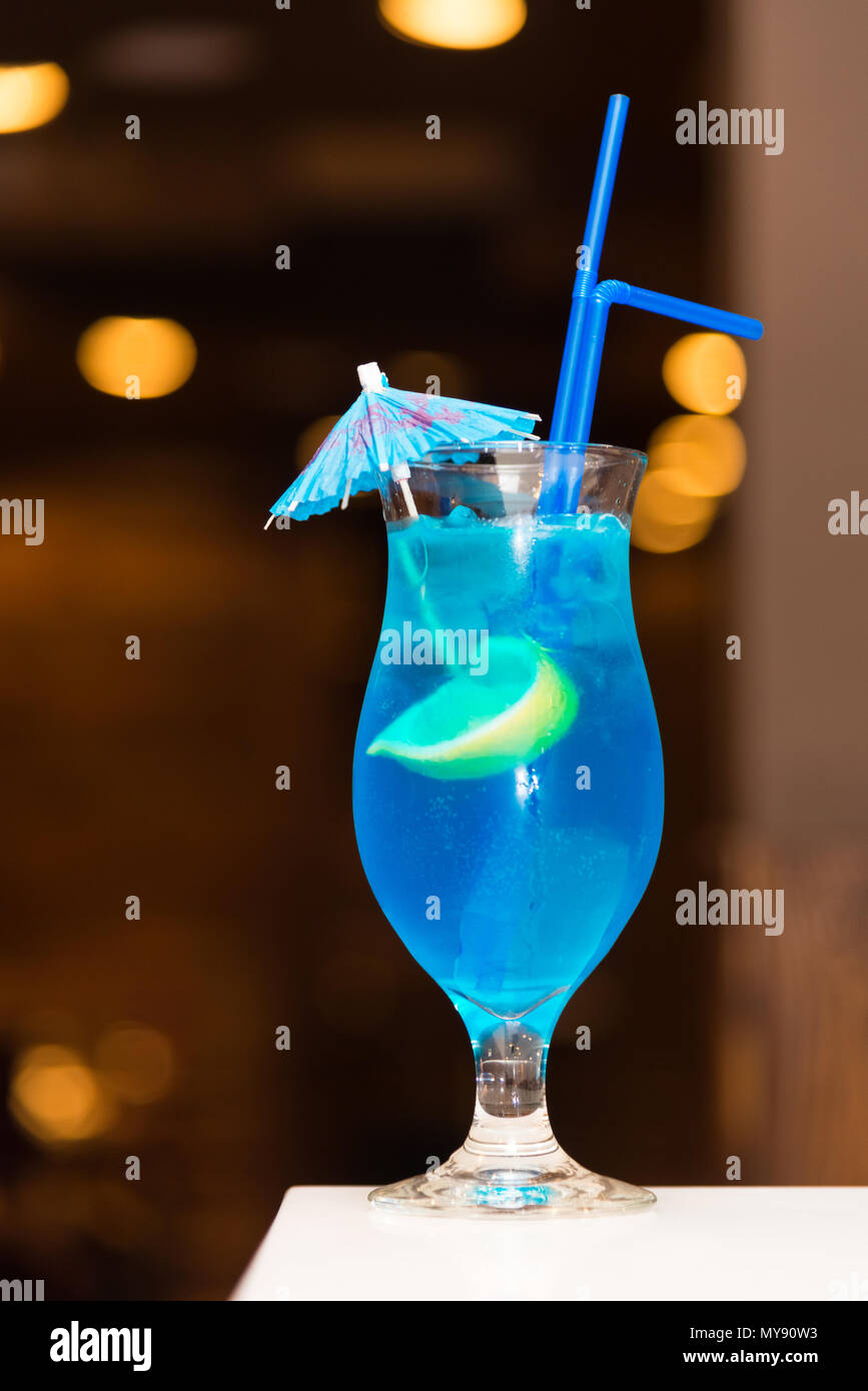 Cocktail with an umbrella and tubules Stock Photo - Alamy