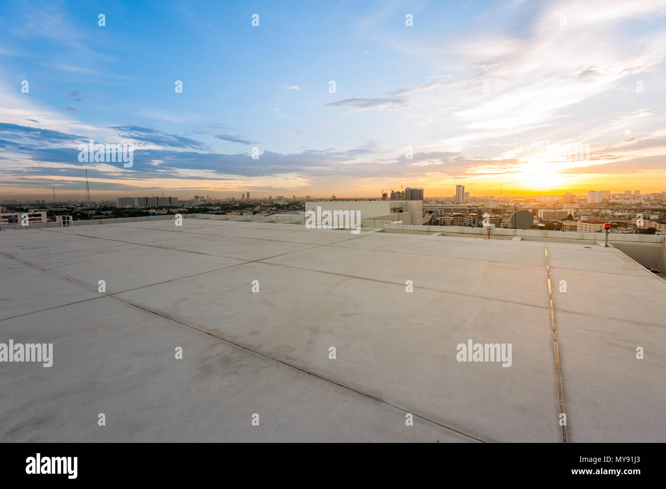 Roof top of building with sunset Stock Photo - Alamy
