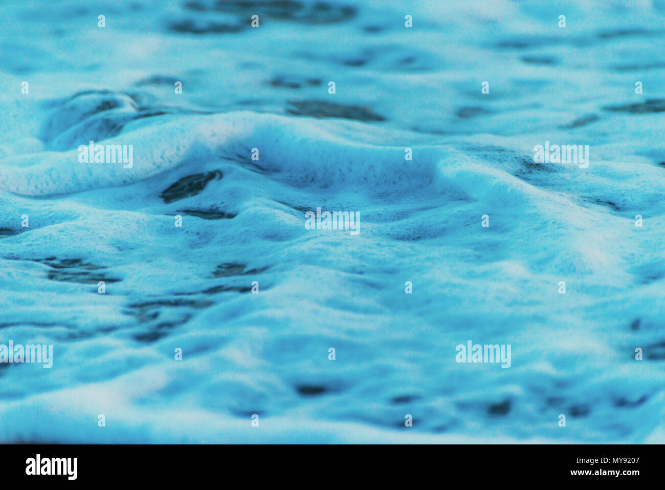 close up of the sea water affecting the sand on the beach, sea waves ...