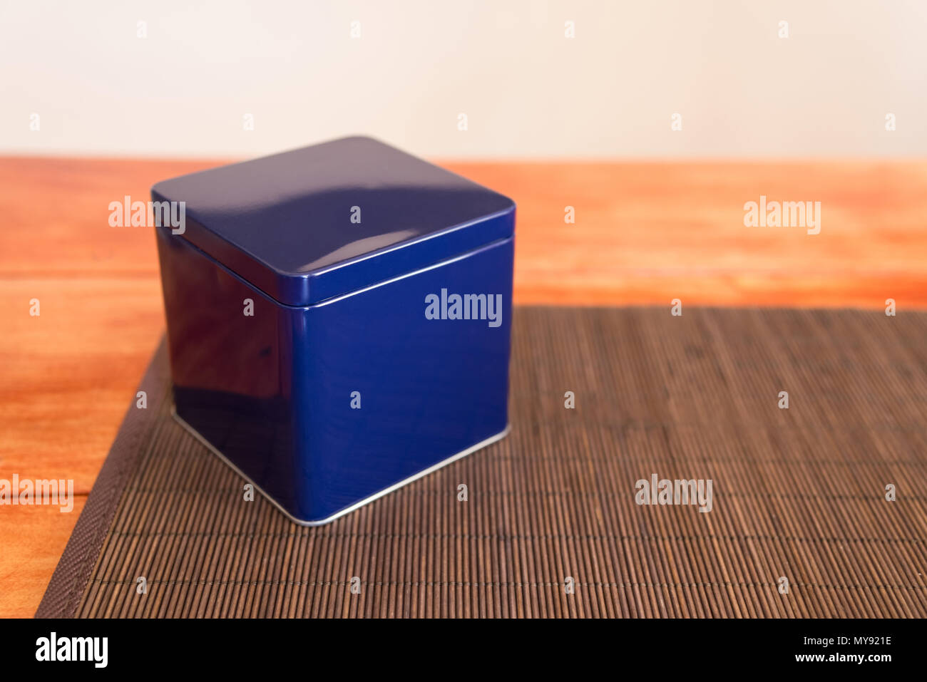 Blue metal box on a bamboo napkin Stock Photo - Alamy