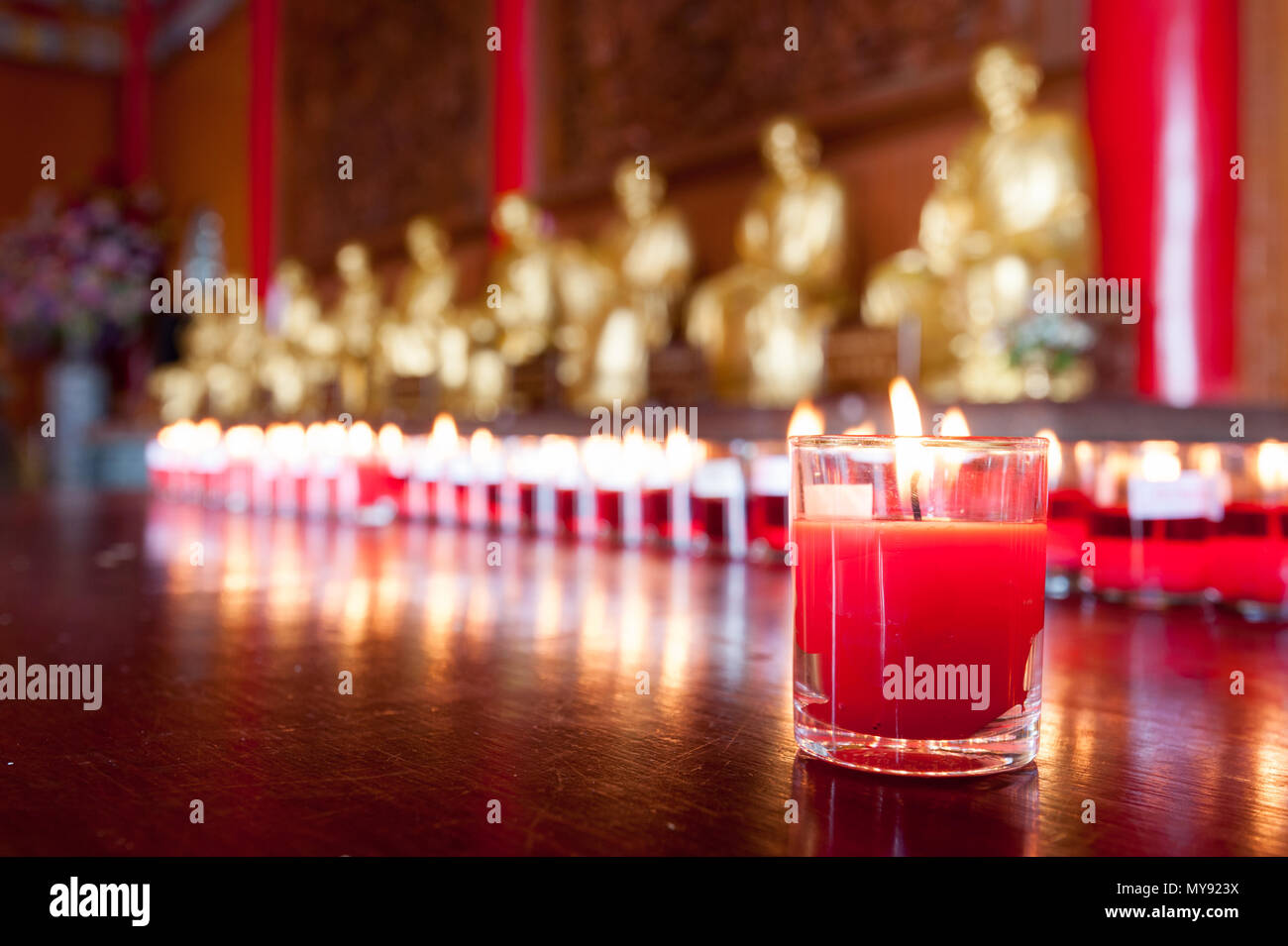 Candles burning in small temple hi-res stock photography and images - Alamy