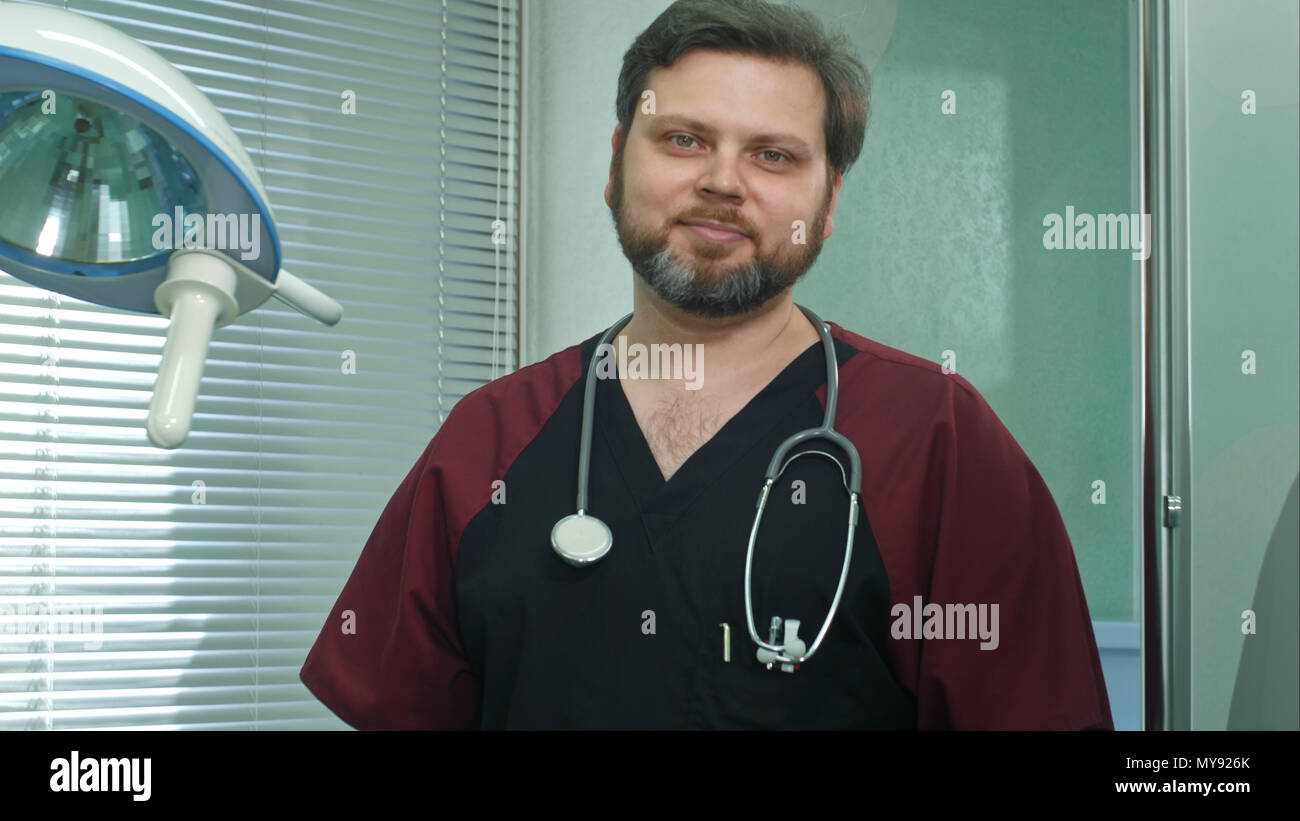 Confident doctor smiles into camera Stock Photo - Alamy