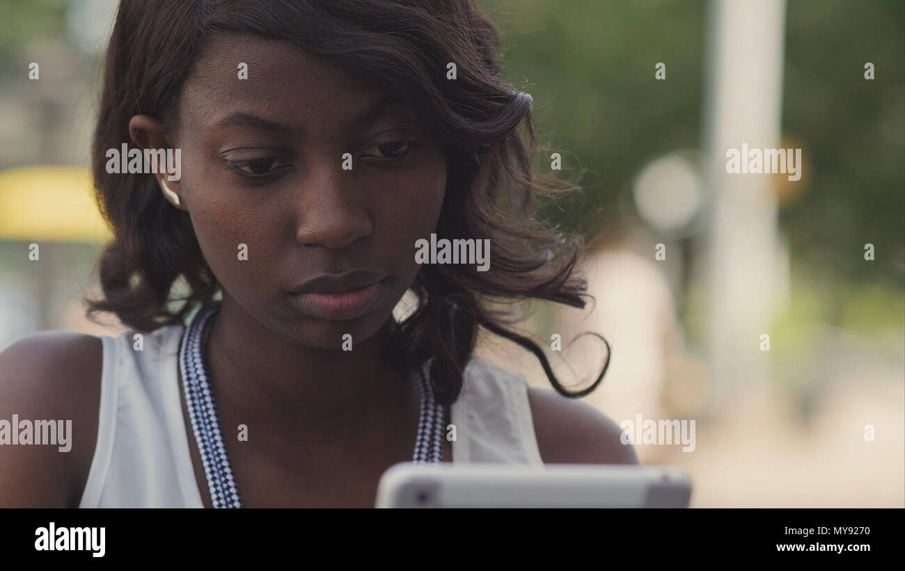 African american woman using her tablet Stock Photo - Alamy
