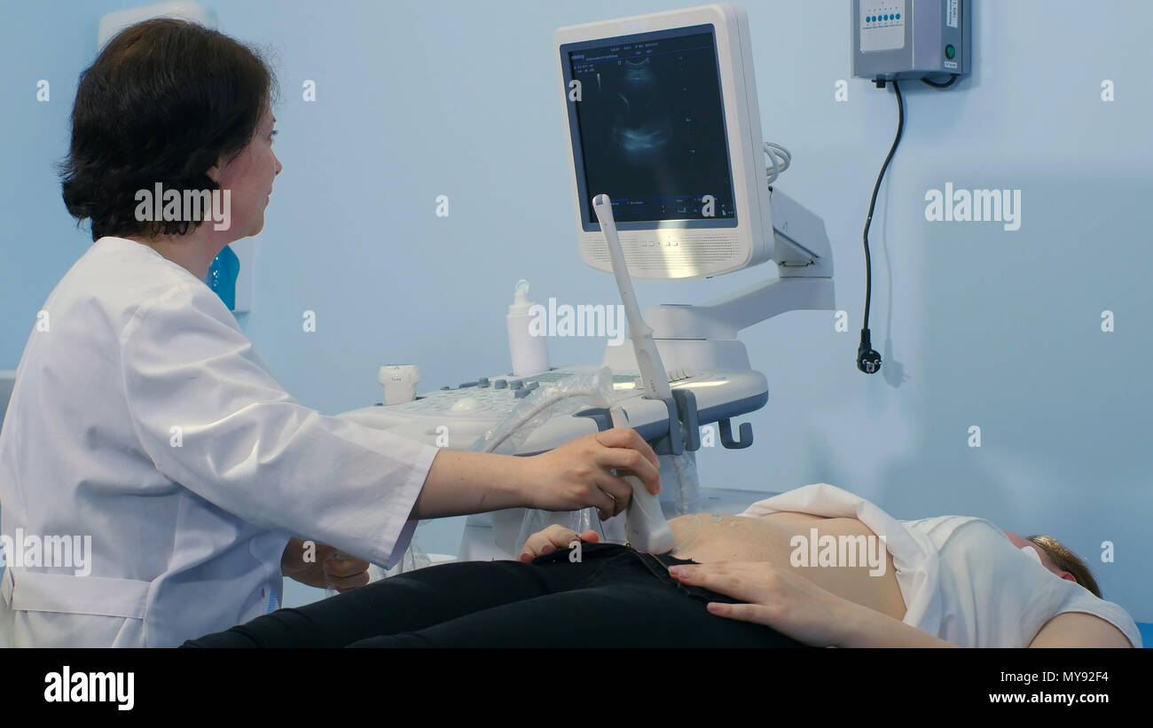 Female doctor putting gel on patient stomach for ultrasound scan Stock ...