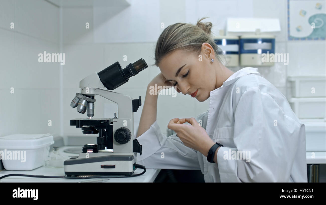 Female medical doctor bored at work Stock Photo - Alamy