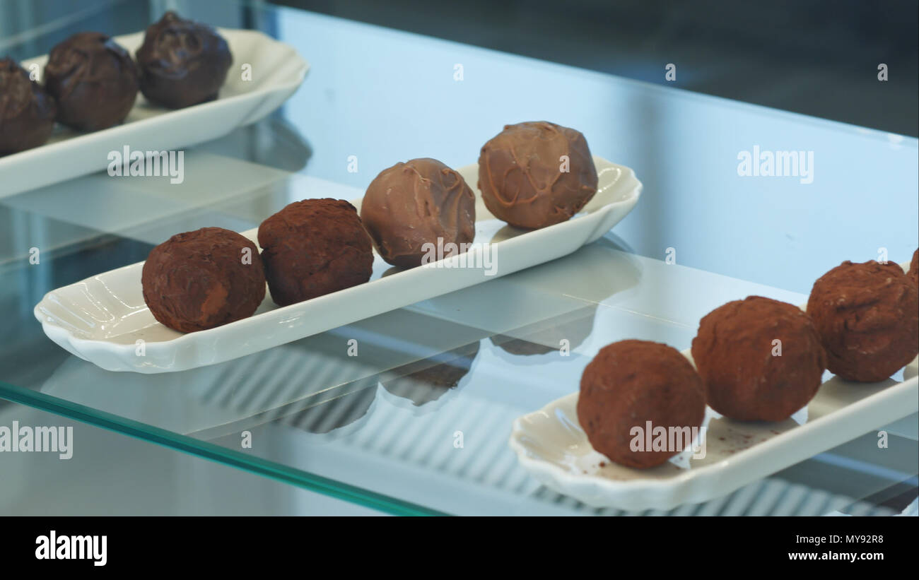 Different sweet candy round chocolate in the shop Stock Photo - Alamy