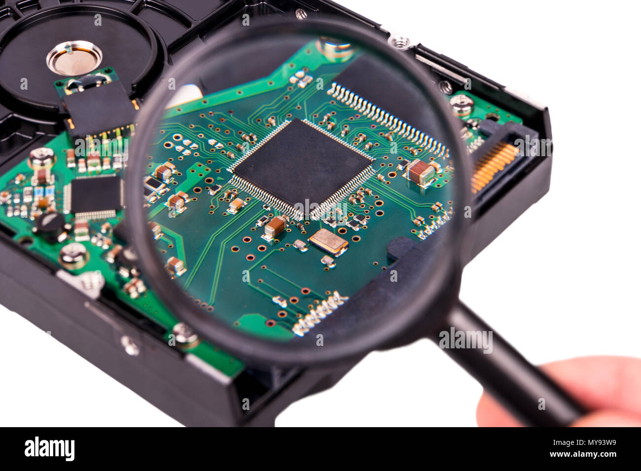 Microchip hard disk is increased under a magnifying glass Stock Photo ...