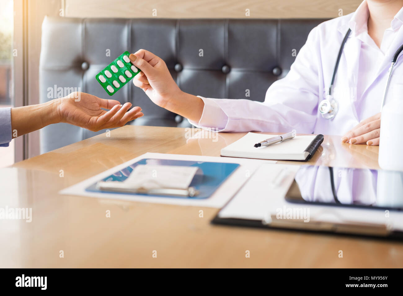 doctor hand holding tablet of drug and explain to patient in hospital ...