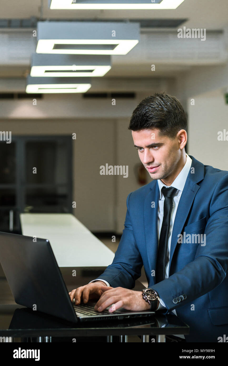 Elegant businessman in suit working on computer in modern office Stock ...