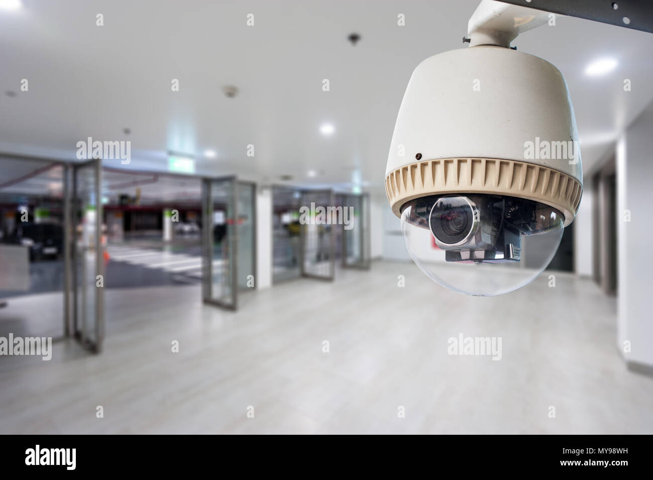 CCTV camera or surveillance operating in building entrance Stock Photo ...