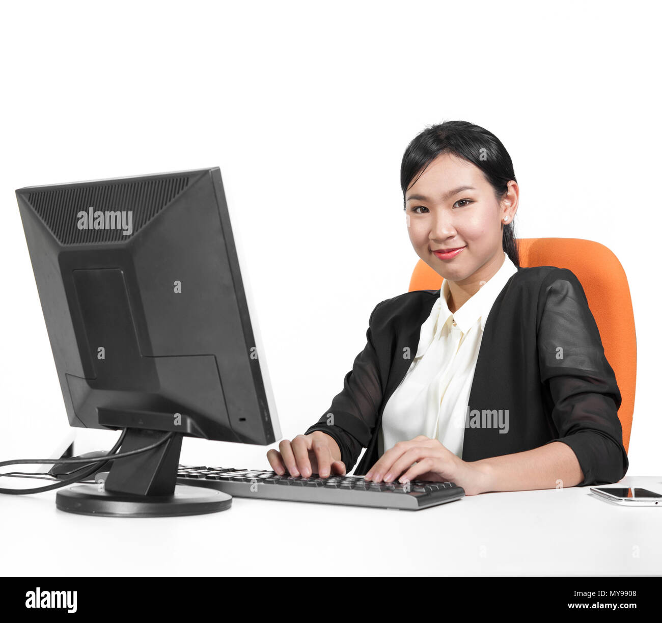 Young pretty business woman using computer on desk Stock Photo - Alamy
