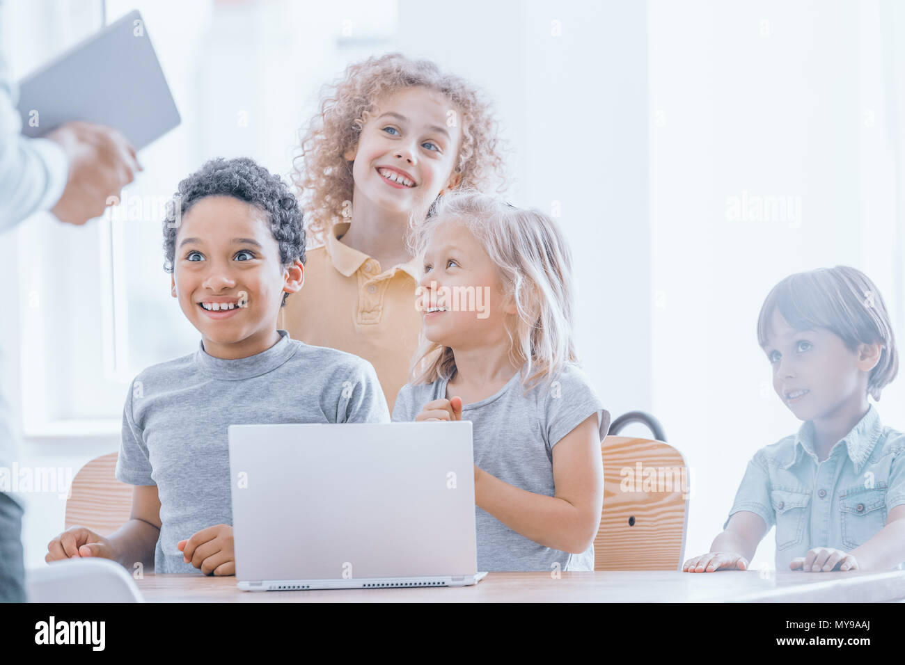 Happy children play well during computer science classes at modern ...