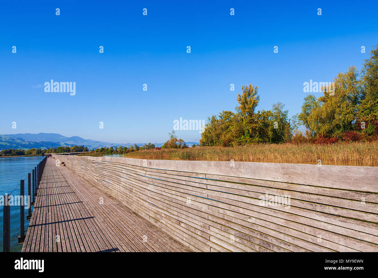 Wooden bridge over Lake Zurich between the town of Rapperswil and the ...