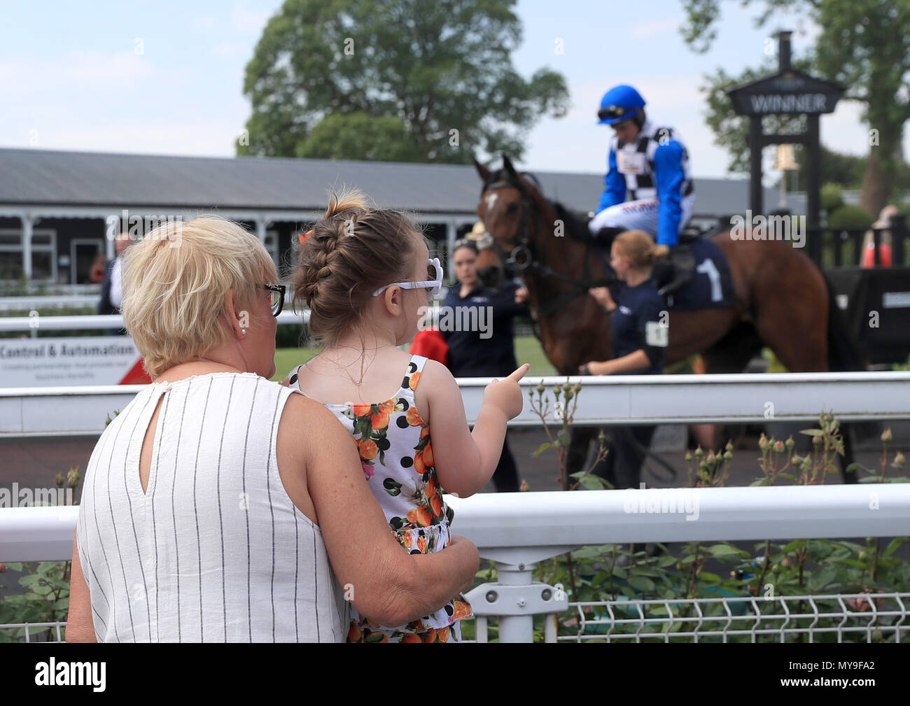 Race goers watch horses in parade ring hi-res stock photography and ...