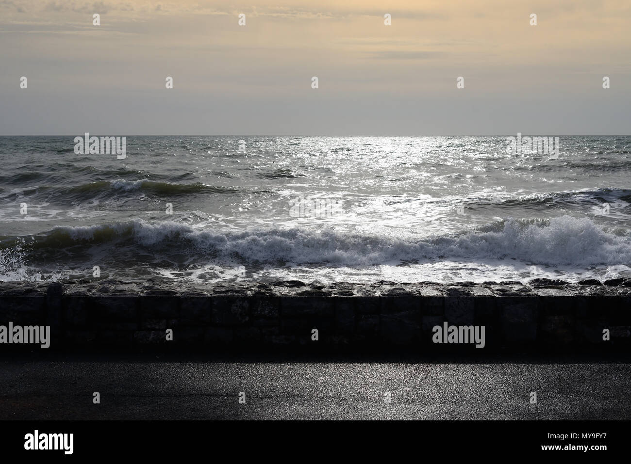 Waves along the seawall at high tide Stock Photo - Alamy