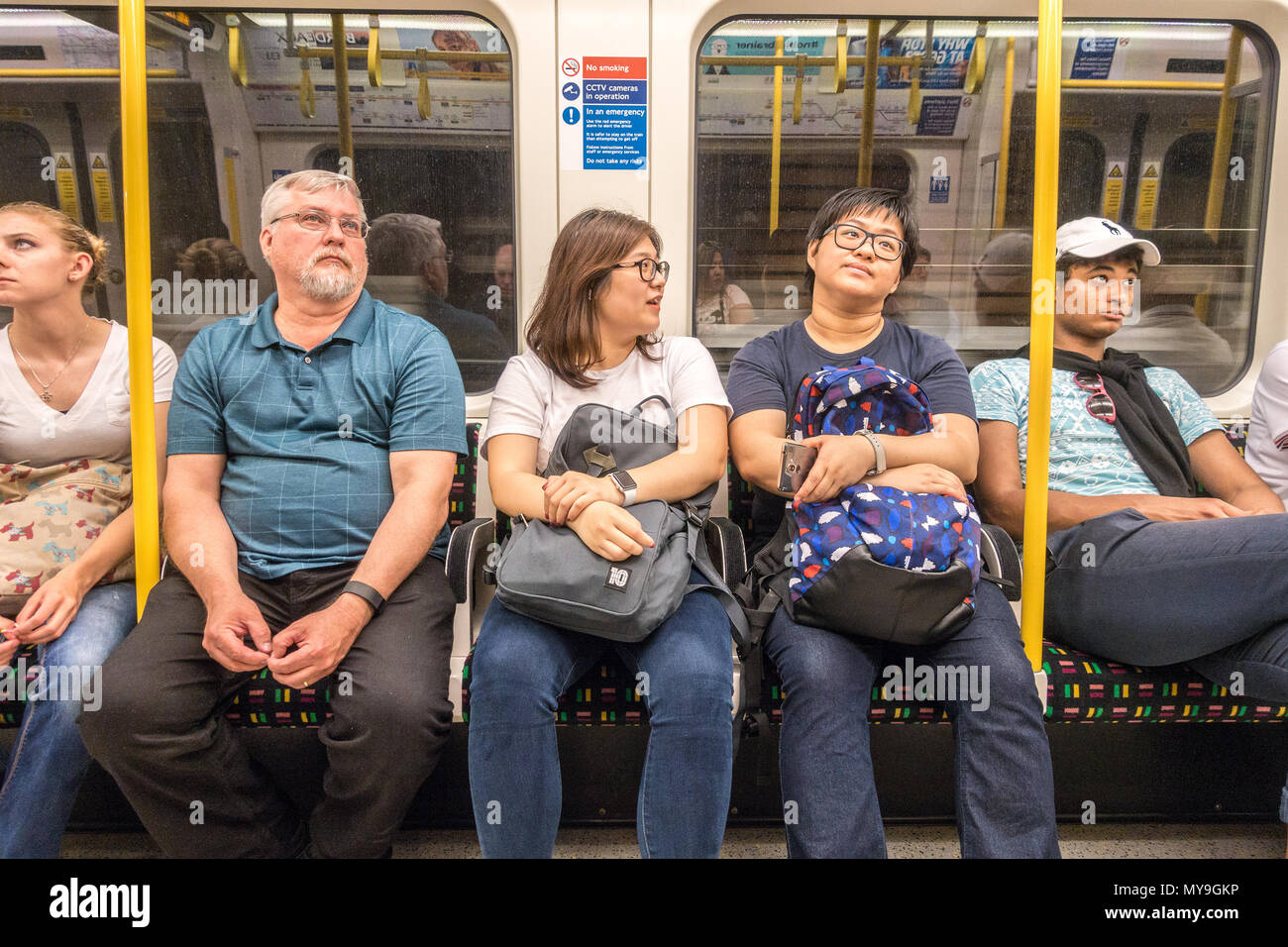 Passengers sitting onboard a London Underground train Stock Photo - Alamy