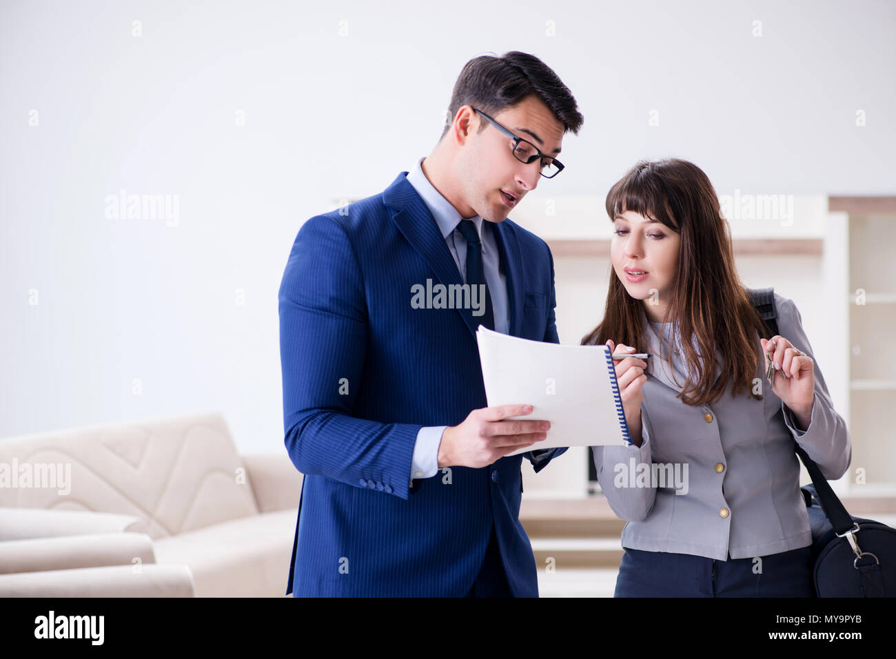Real estate agent showing new apartment to owner Stock Photo - Alamy