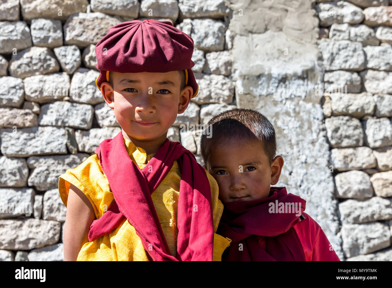 Two Tibetan monk boys in traditional red Buddhist costumes. India ...