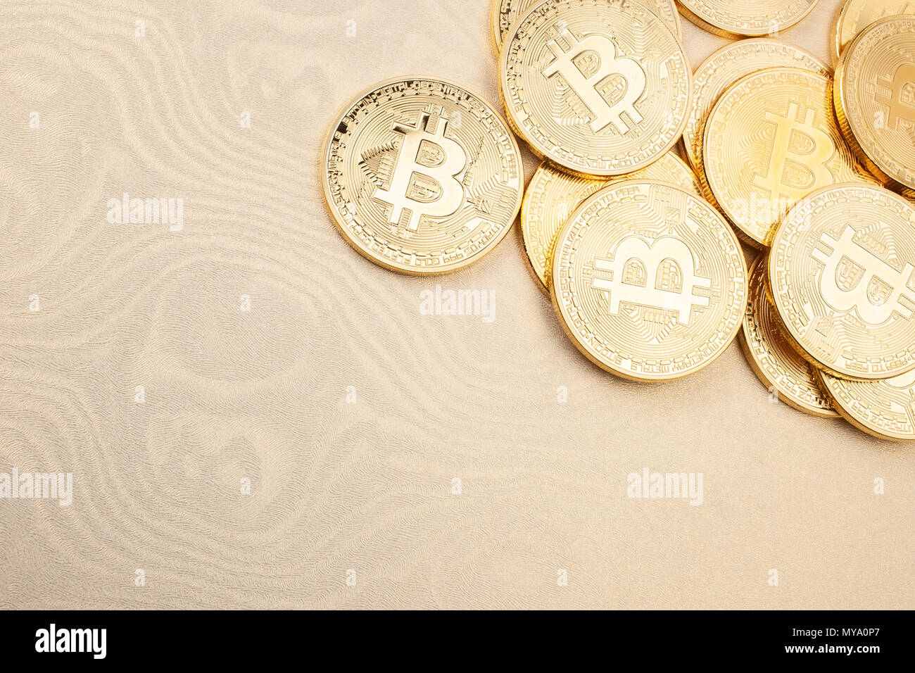 Bitcoins on gold background Stock Photo - Alamy