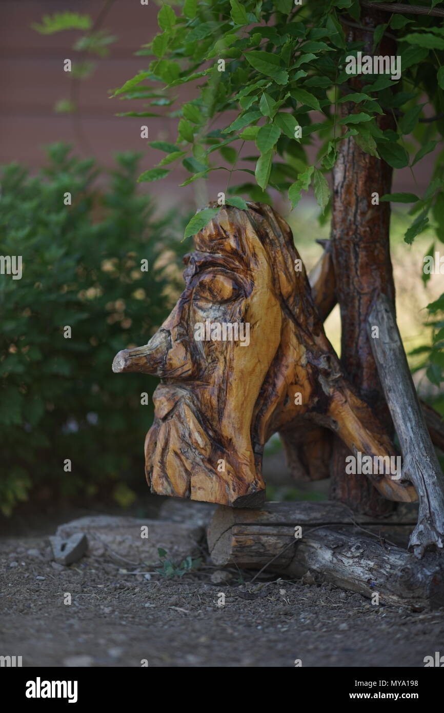 wooden face in the garden Stock Photo - Alamy