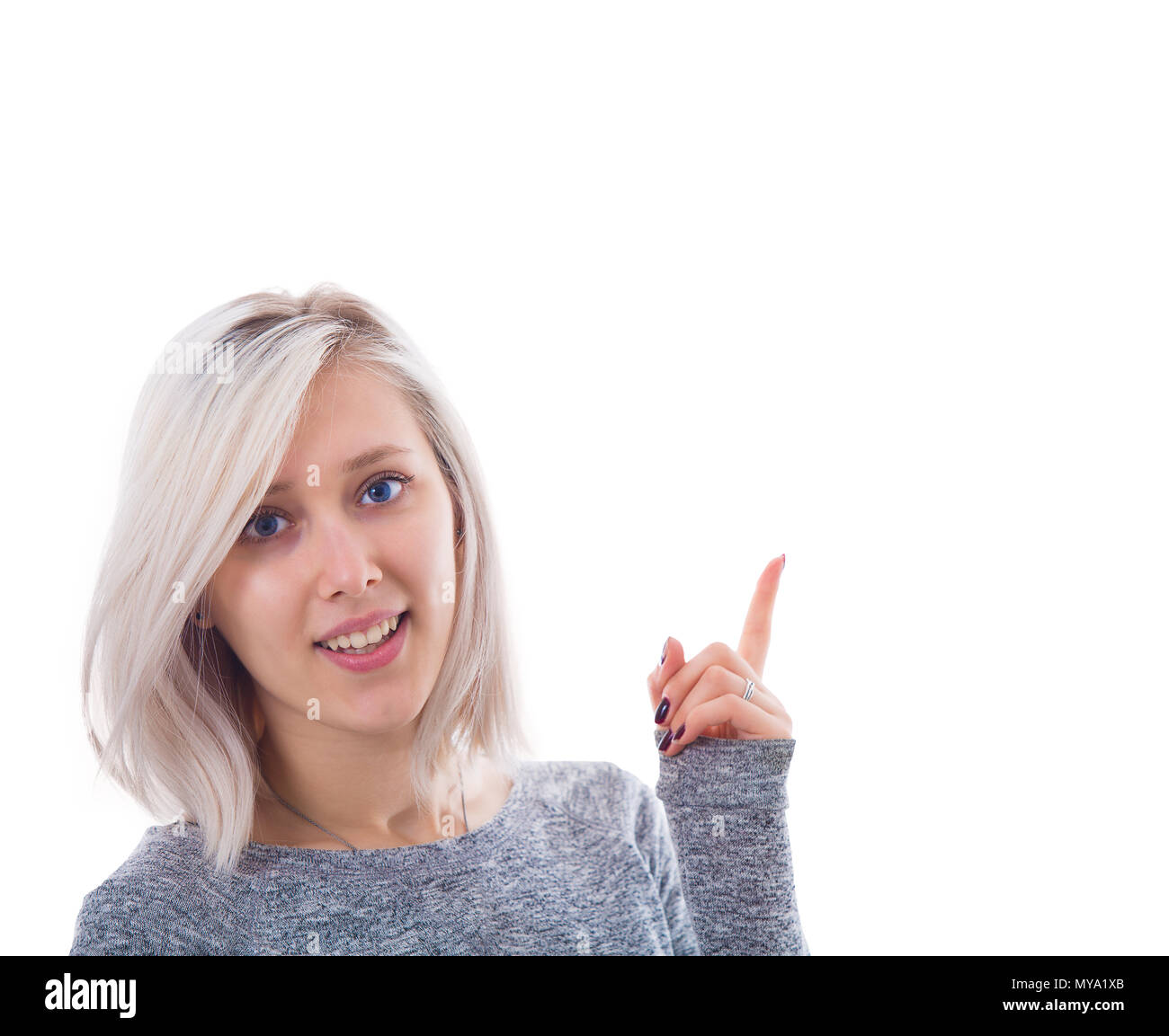 Close up portrait of smiling woman pointing her finger up isolated on ...