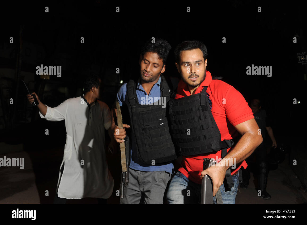 Dhaka, Bangladesh - July 01, 2016: Police carry an injured man near the ...