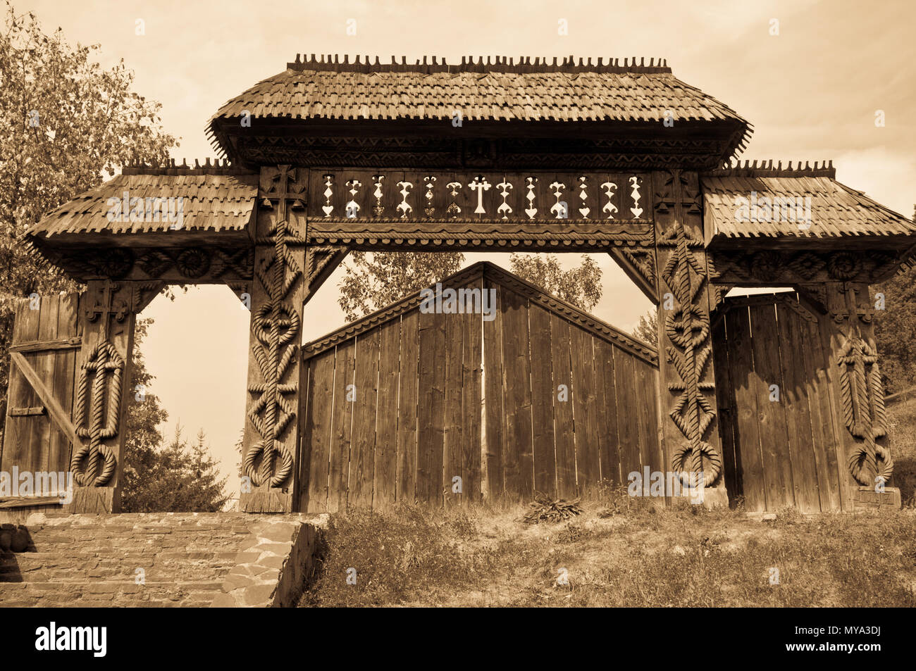 Traditional carved wooden gate from Maramures region, Romania, sepia ...