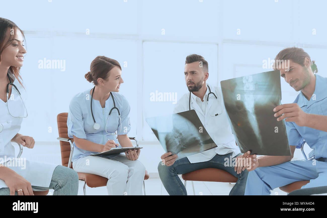 group of surgeons and medical professional staff discussing on patient ...