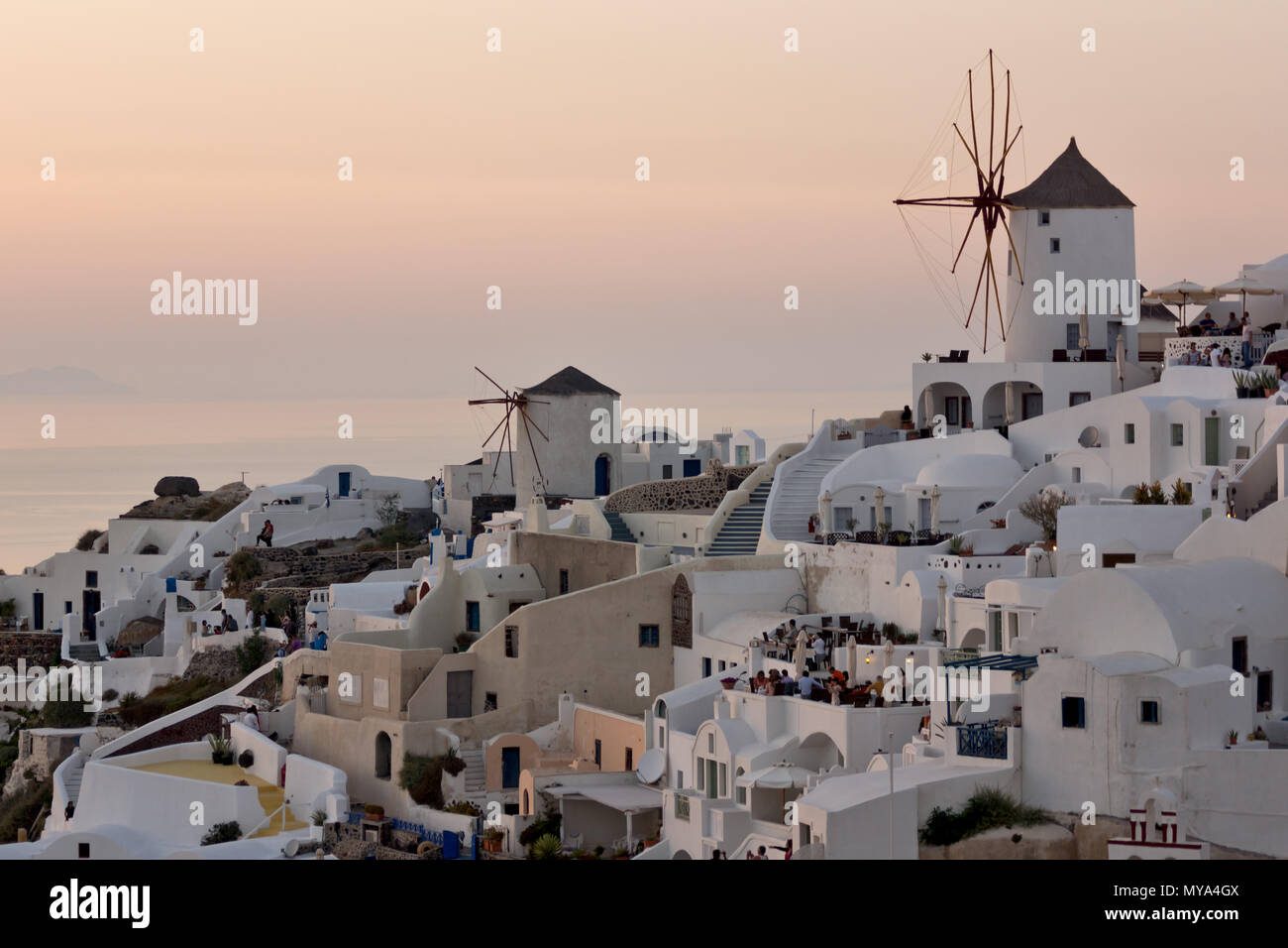 Amazing Sunset over white windmills in town of Oia and panorama to ...