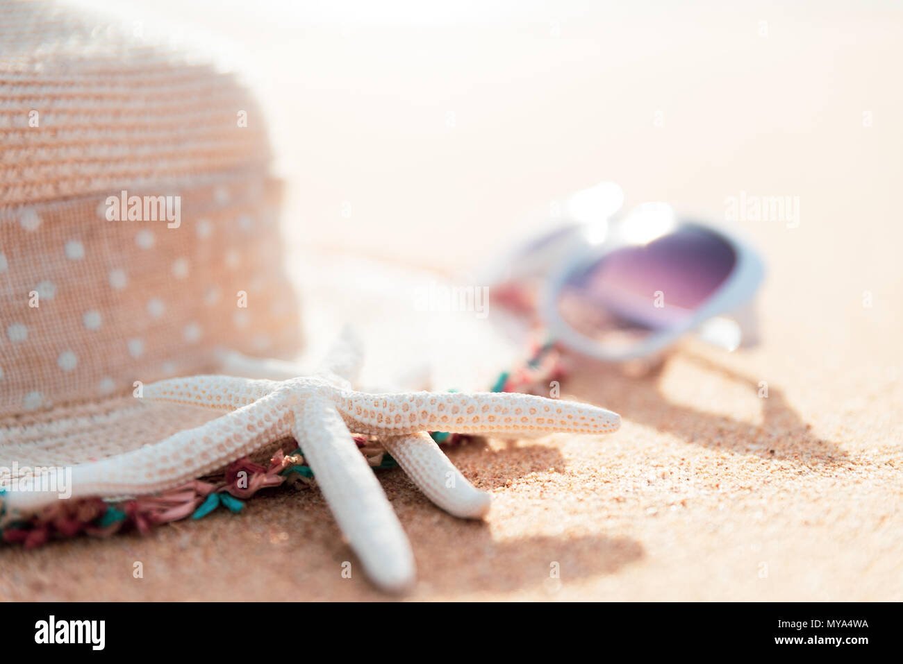 Soft focus on starfish. Beach accessories including sunglasses ...