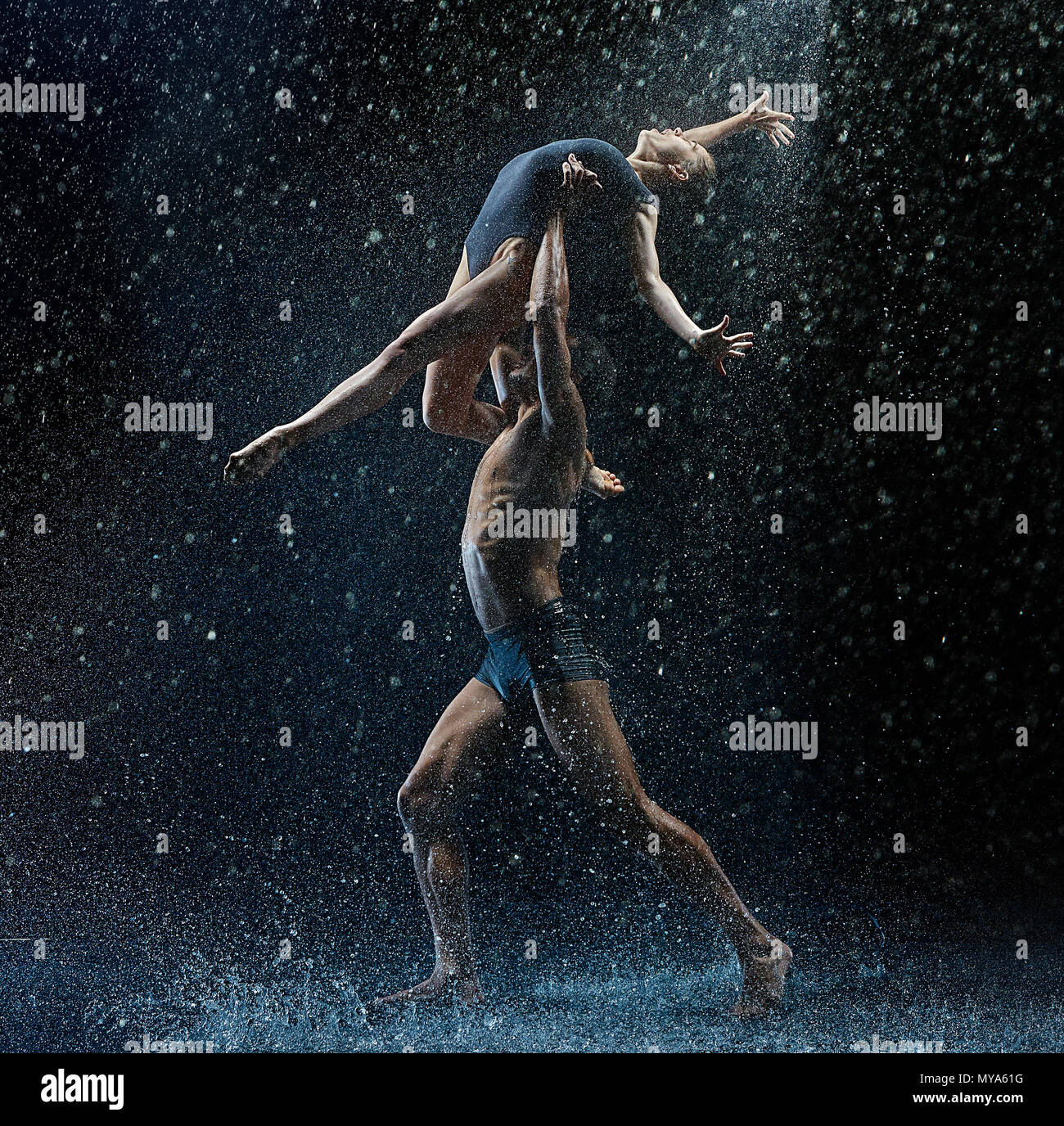 Young couple of ballet dancers dancing under water drops Stock Photo ...